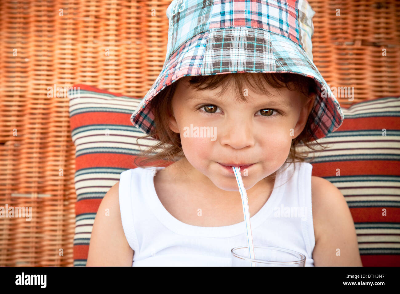 child drinking juice through straw Stock Photo - Alamy