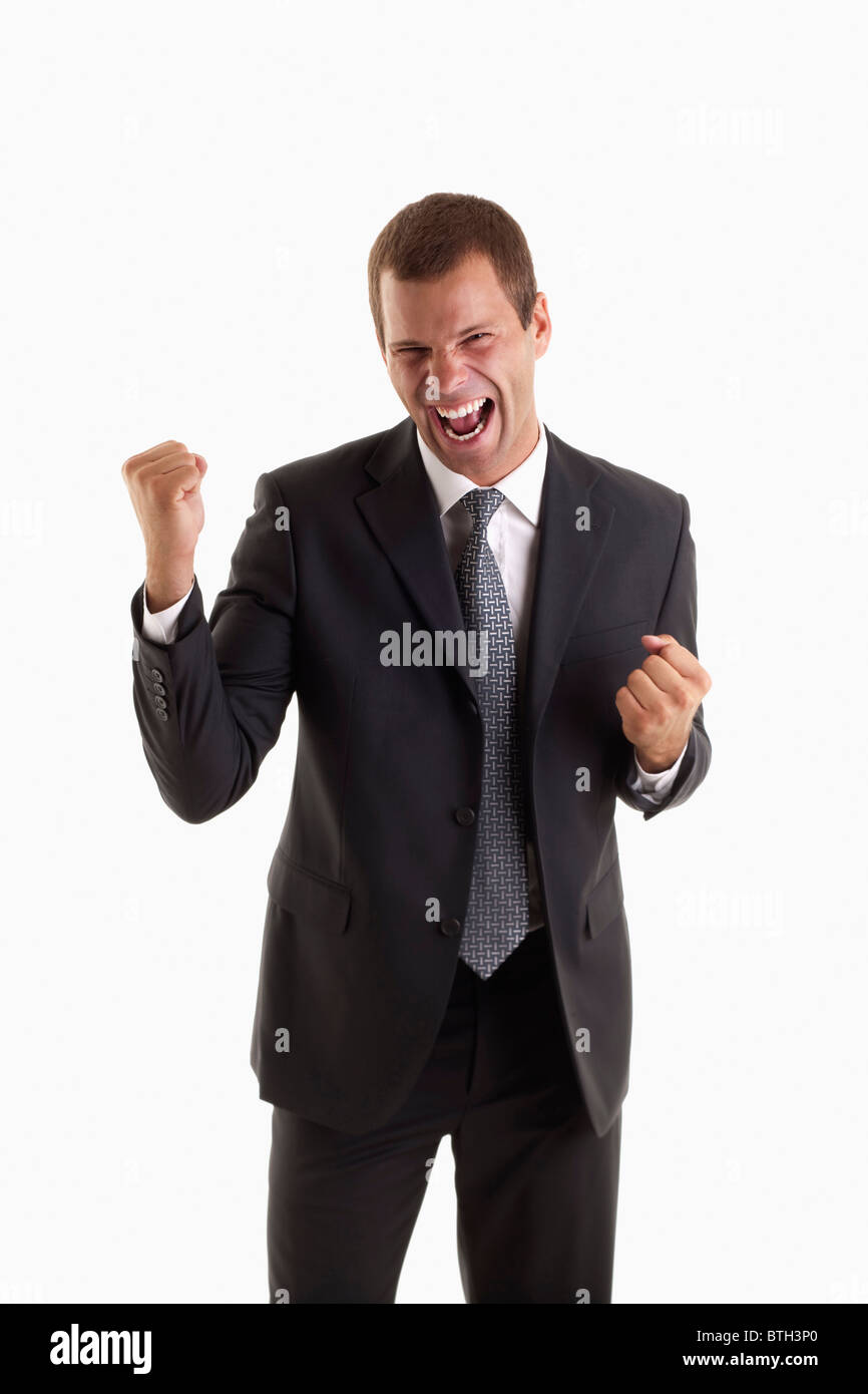 Victorious man holding fists up and shouting Stock Photo - Alamy