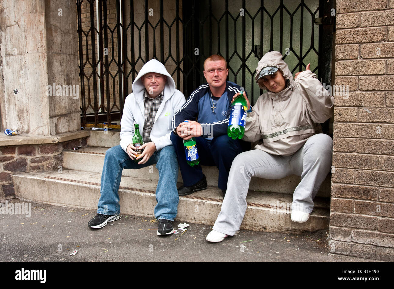 Three street drinkers doing what they do best Stock Photo - Alamy