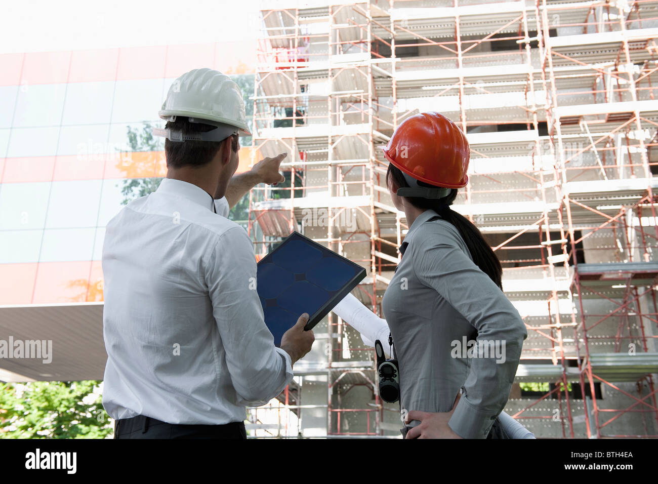 Professionals with hardhats at construction site Stock Photo - Alamy