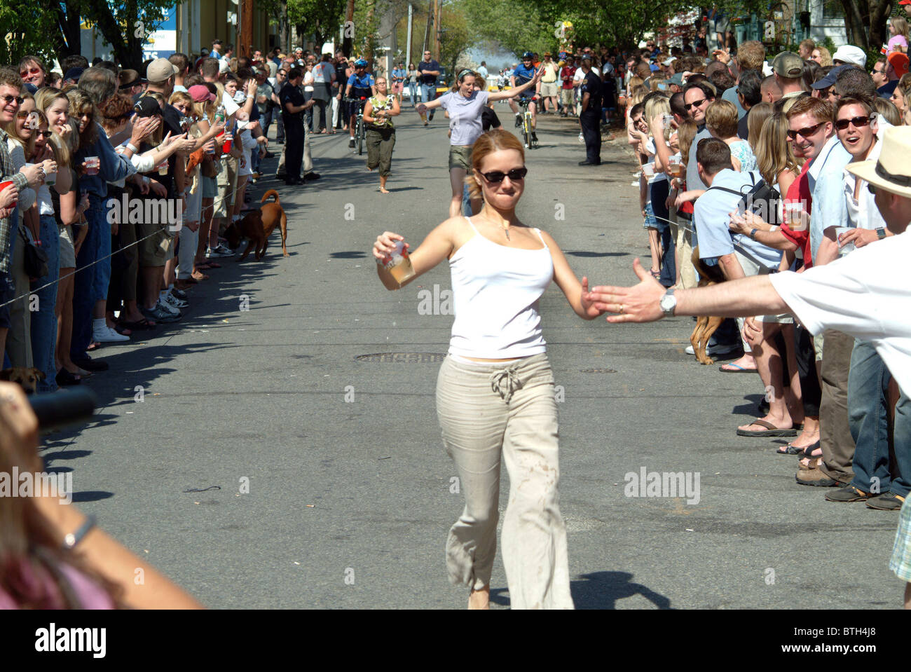 Woman congratulated at finish line of beer race in Eastport, Md Stock ...