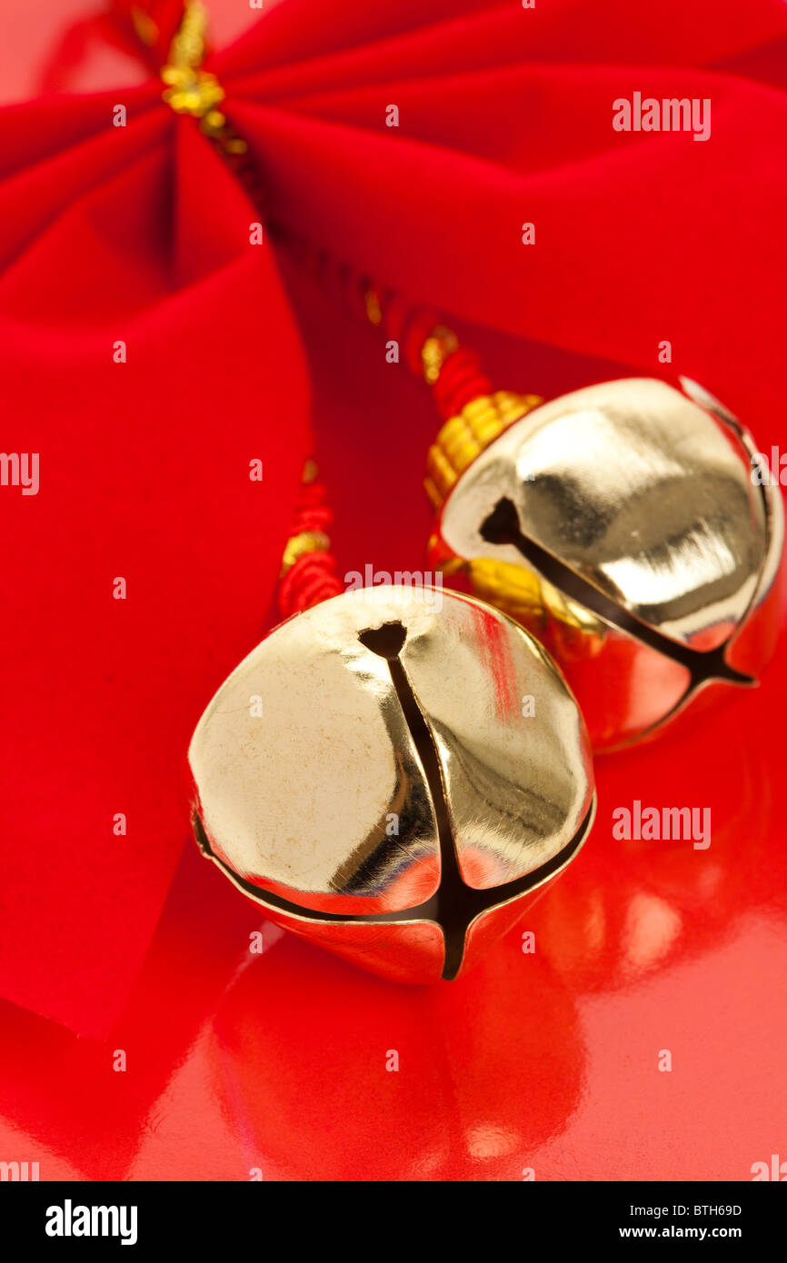Christmas Bells and ribbon with red background Stock Photo - Alamy