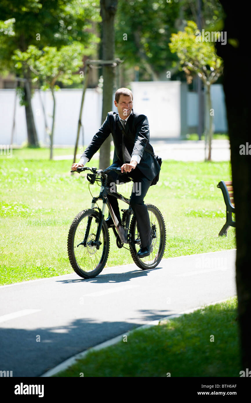 Businessman cycling in park hi-res stock photography and images - Alamy