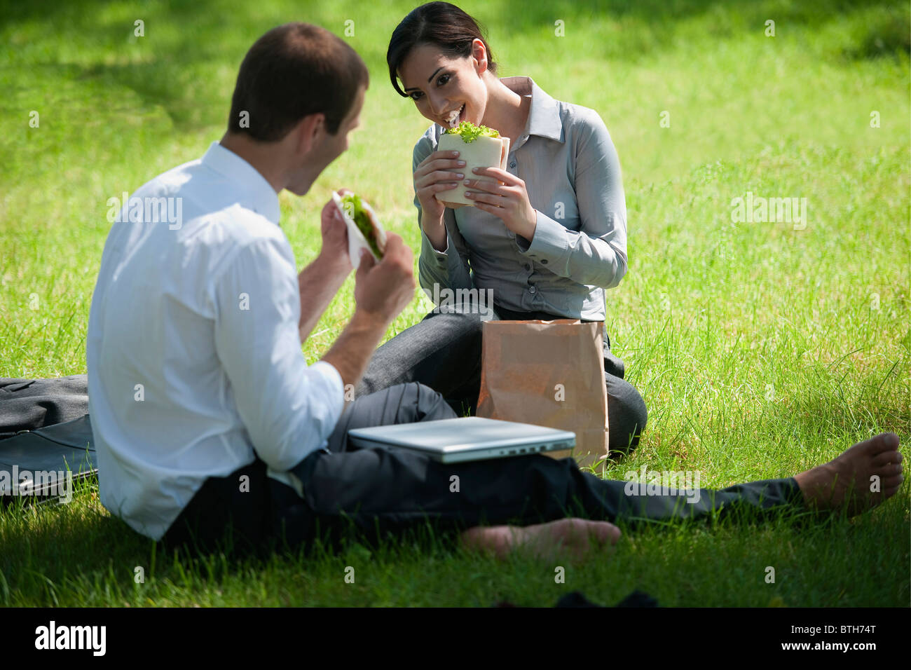 Business people eating lunch on grass Stock Photo - Alamy