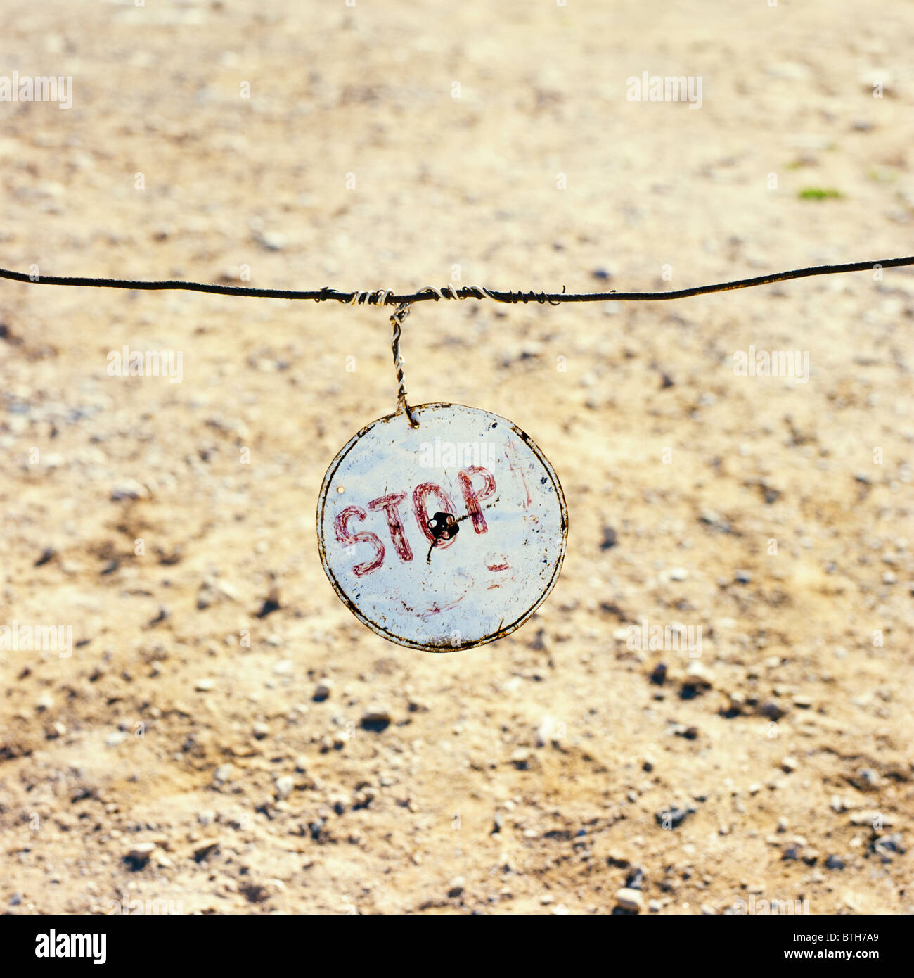 old metal stop sign on wire Stock Photo - Alamy