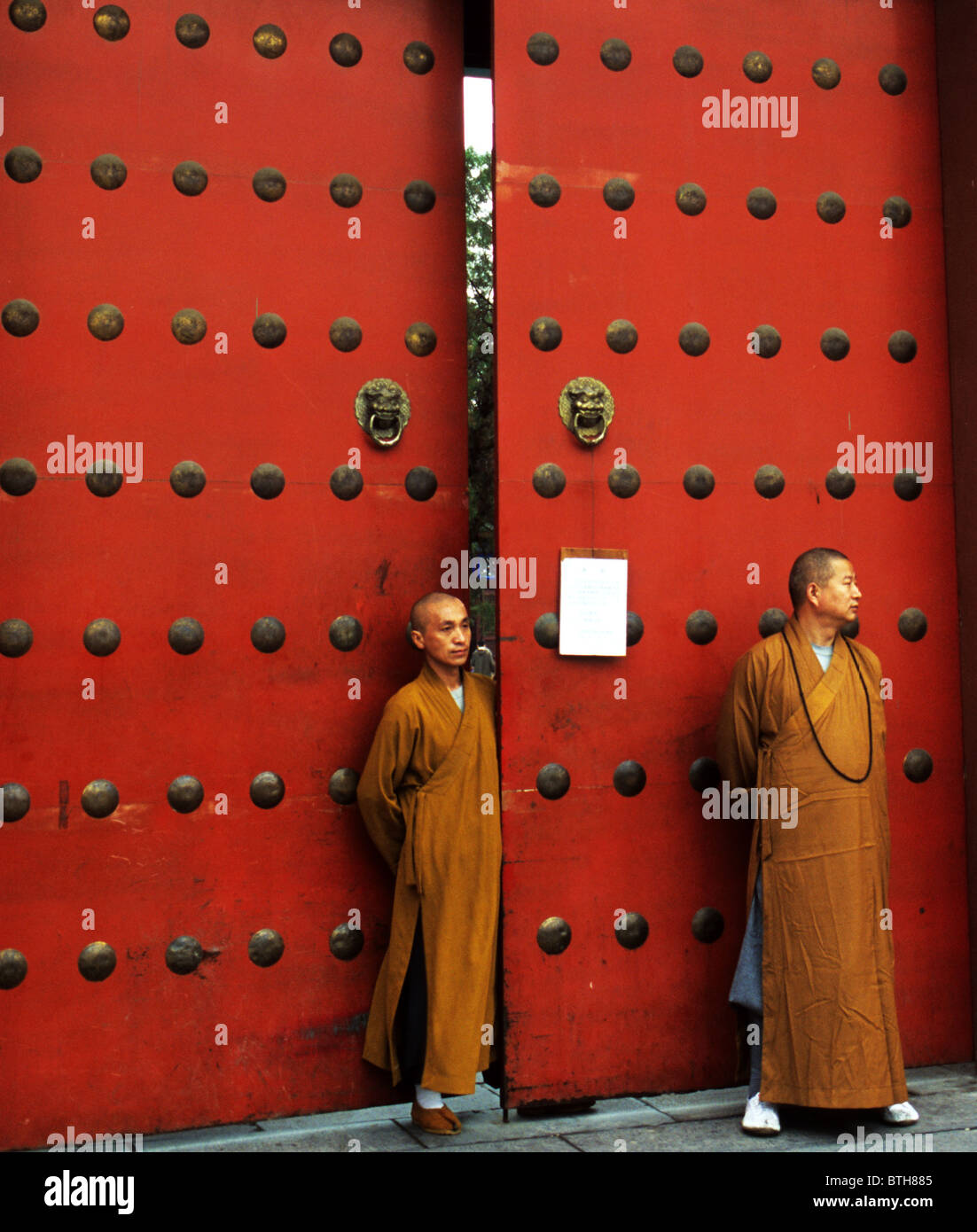 Buddhist monks stand at the gate of their temple. Henan,China Stock ...