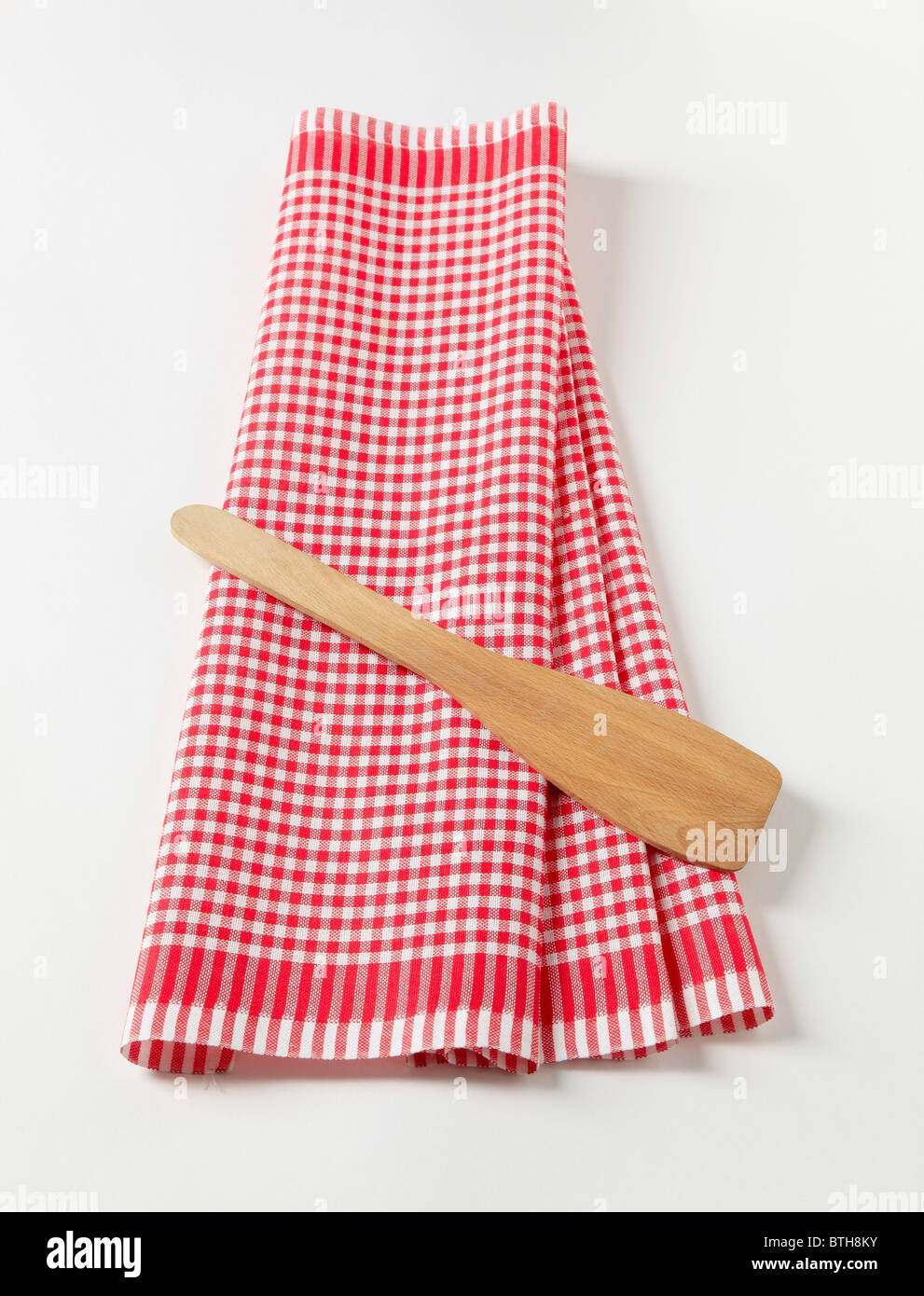 Red and white tea towel and wooden spatula Stock Photo - Alamy