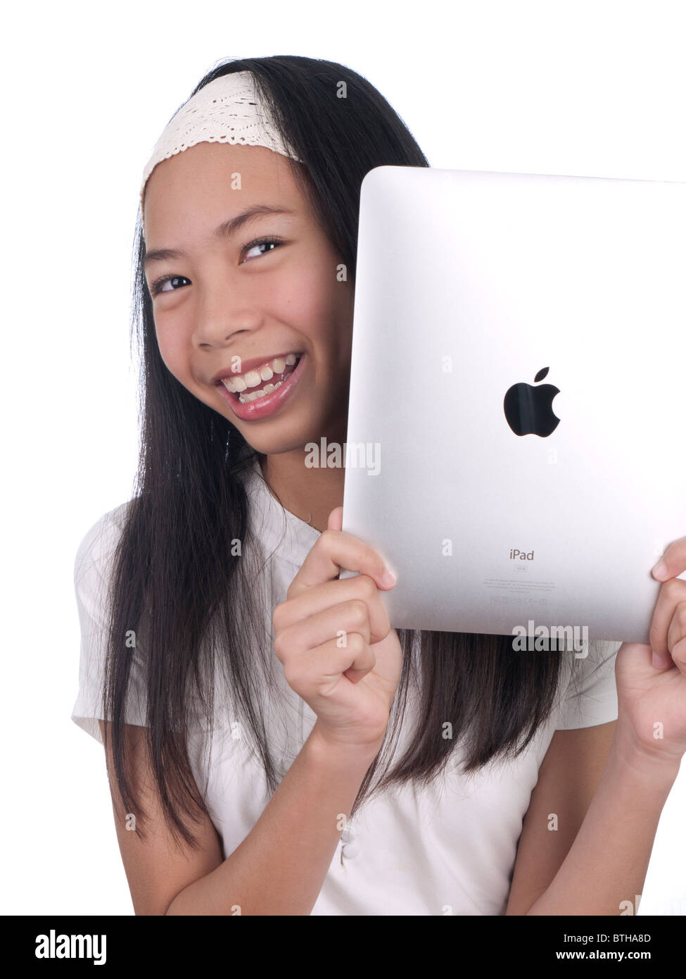 A teenage girl laughs while holding her iPad Stock Photo - Alamy
