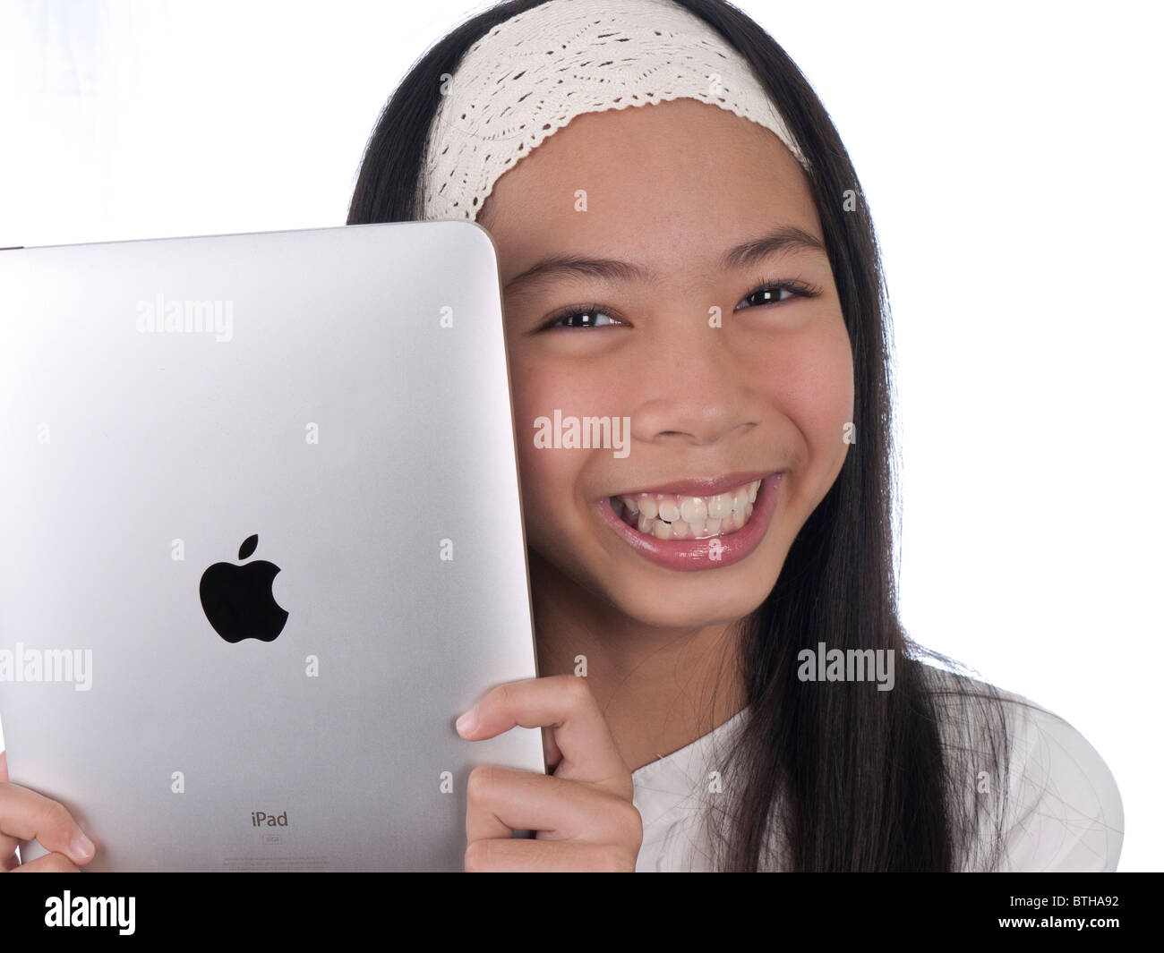 A teenage girl laughs while holding her iPad Stock Photo - Alamy