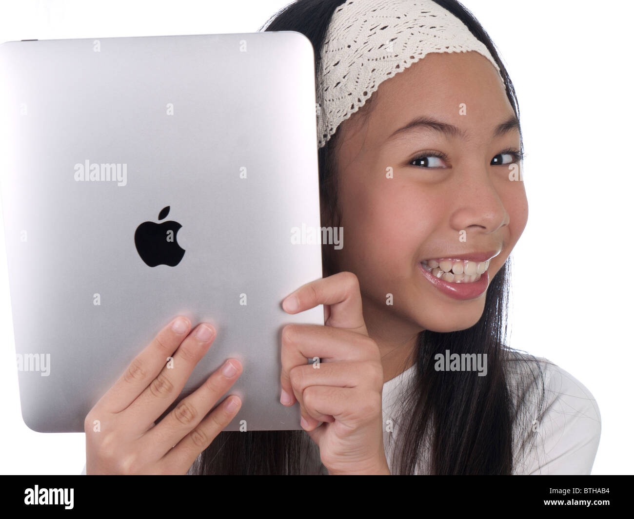 A teenage girl holds her iPad Stock Photo - Alamy