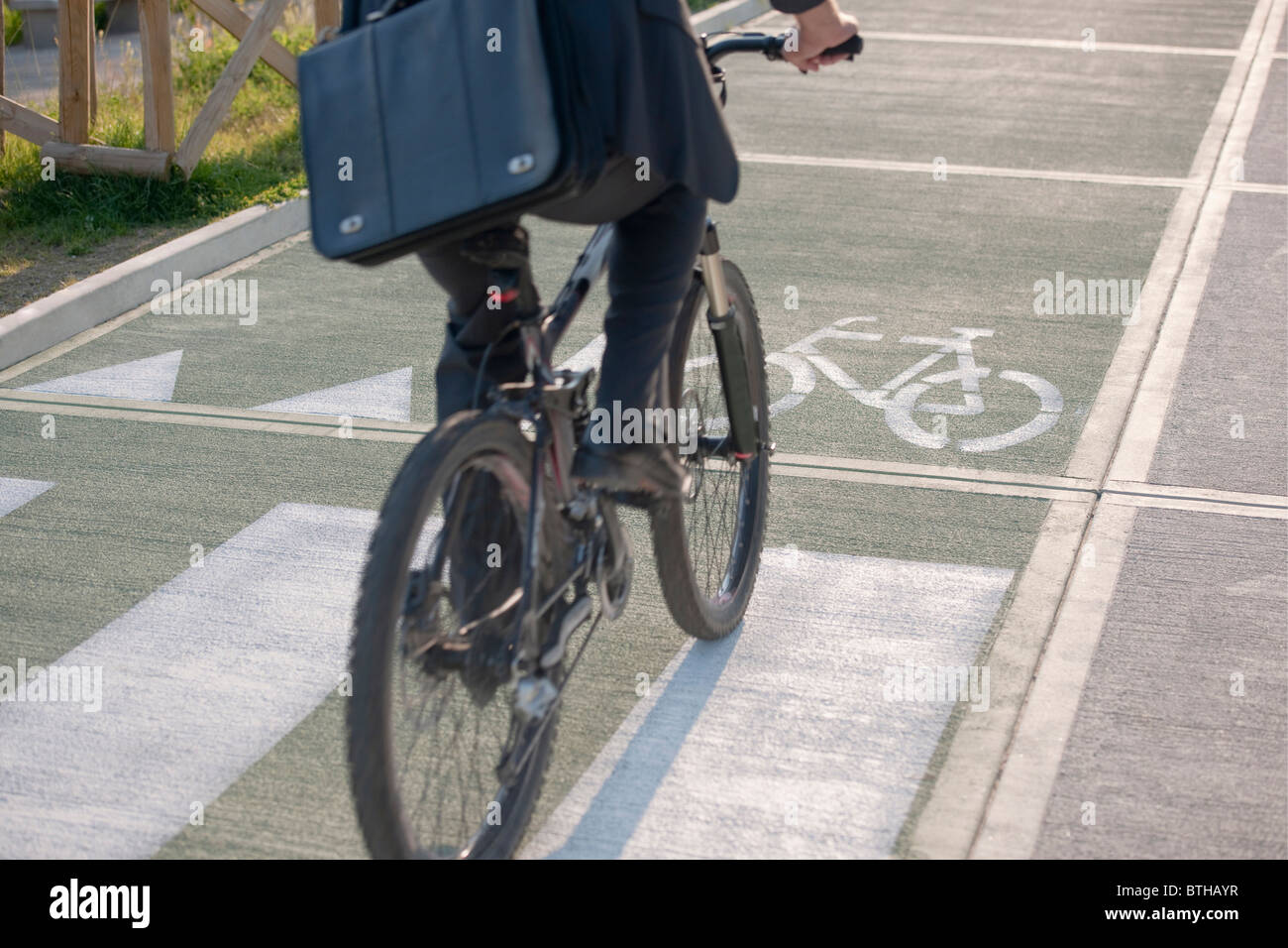 Partial view of man riding bicycle in bicycle lane Stock Photo - Alamy