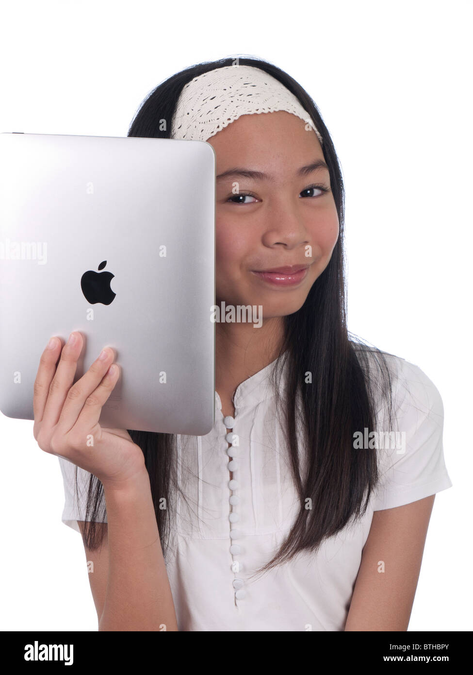 A teenage girl smiles while holding her iPad Stock Photo - Alamy