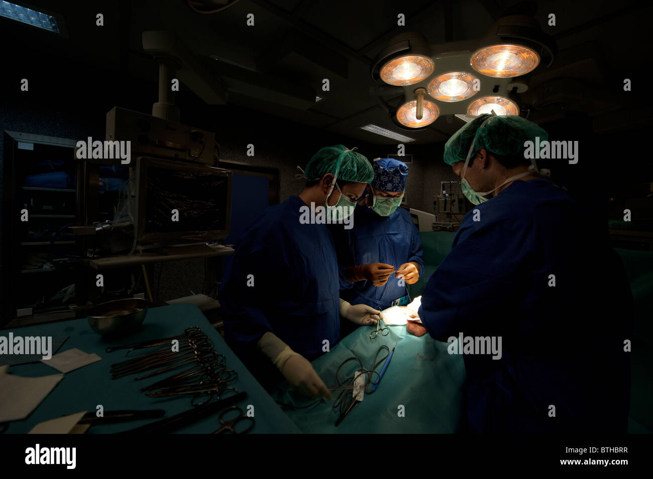 Doctors performing surgery in operating room Stock Photo - Alamy