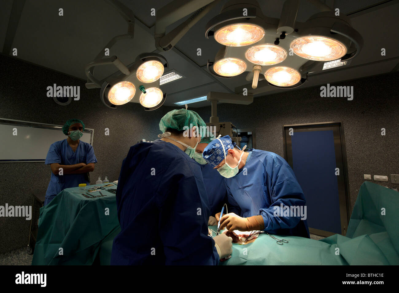 Doctors performing surgery in operating room Stock Photo - Alamy