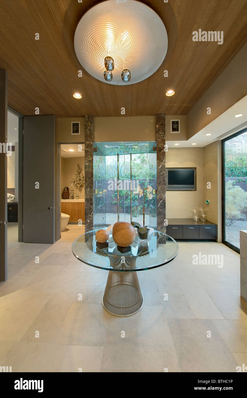 Glass topped table in reception room of California home Stock Photo - Alamy