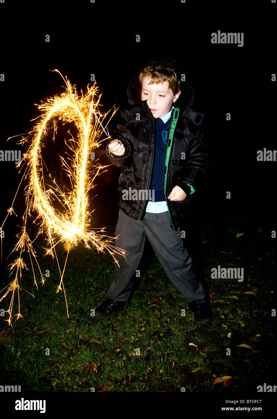Boy holding fireworks sparklers hi-res stock photography and images - Alamy