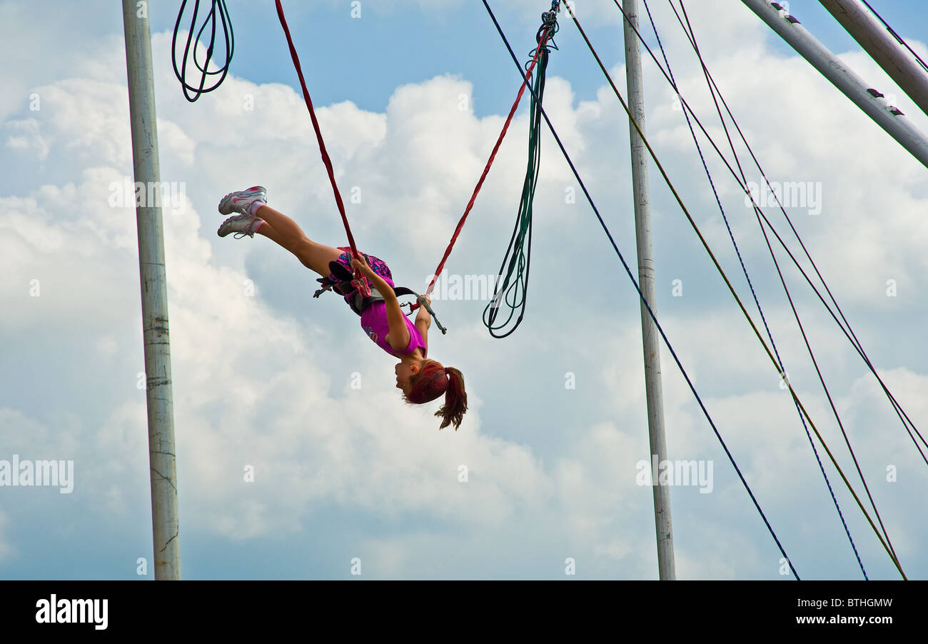 the girl teenager jumping on bungee during air show in Illinois Stock ...