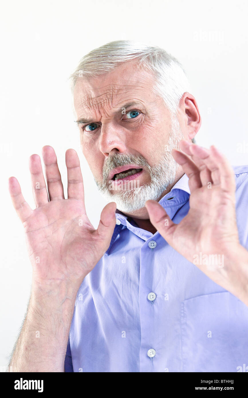 caucasian senior man portrait shielding afraid isolated studio on white ...