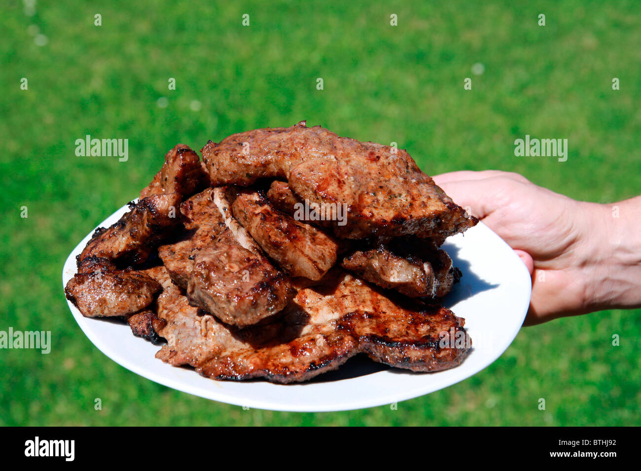 grilled pig meat on plate Stock Photo - Alamy