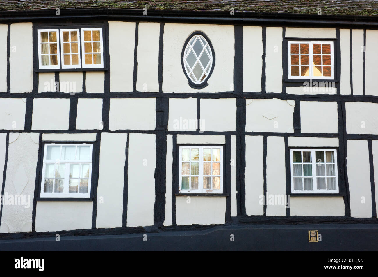 A pattern of ornate windows on a historical timber framed house in St ...