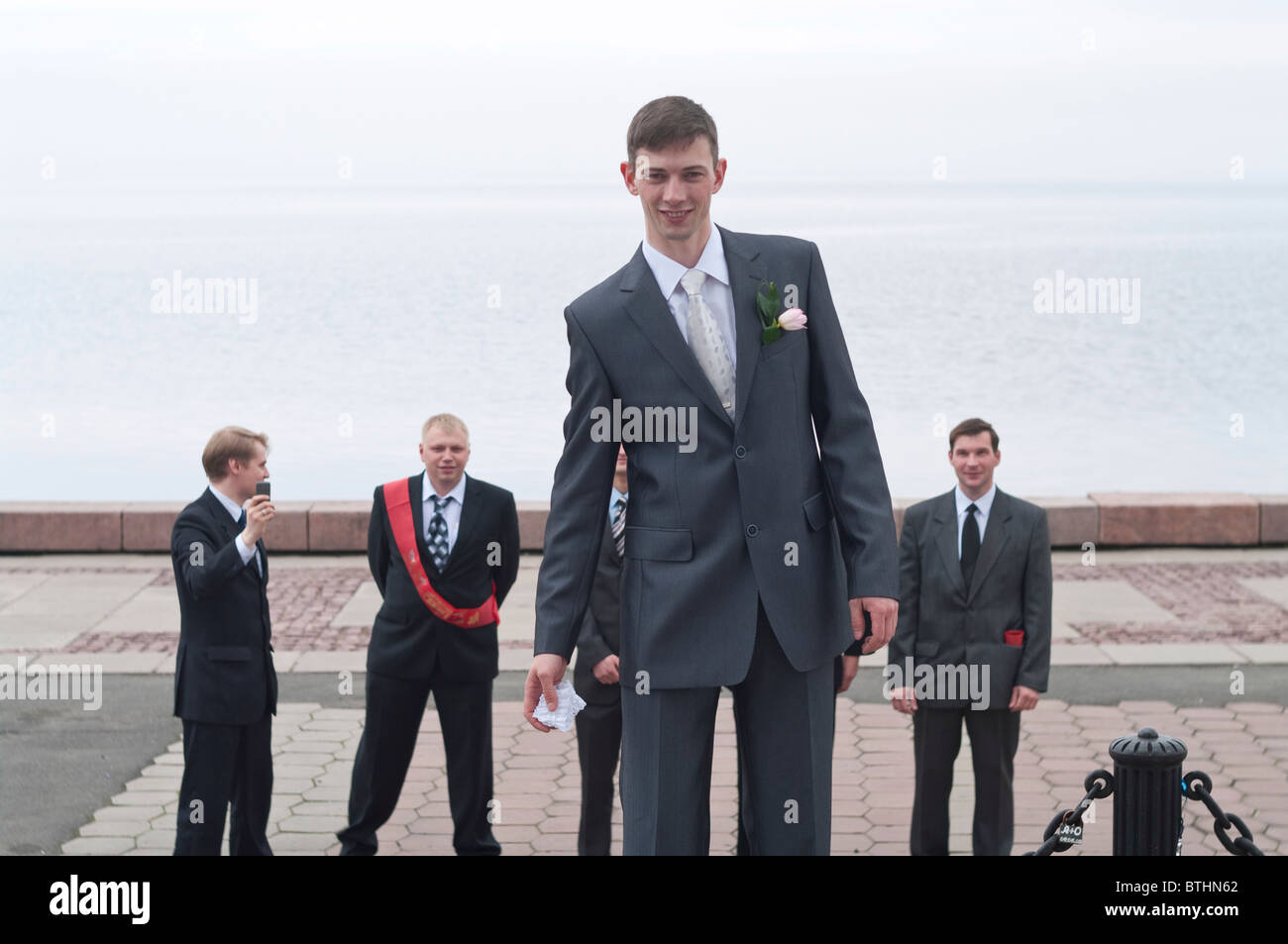 Man the groom throws the garter standing with his back to the guests ...