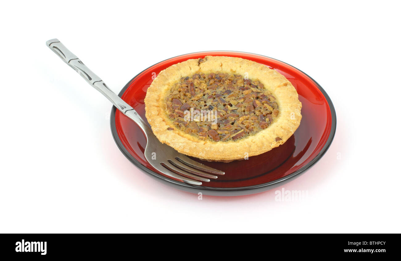 Pecan pie on red plate with fork Stock Photo - Alamy