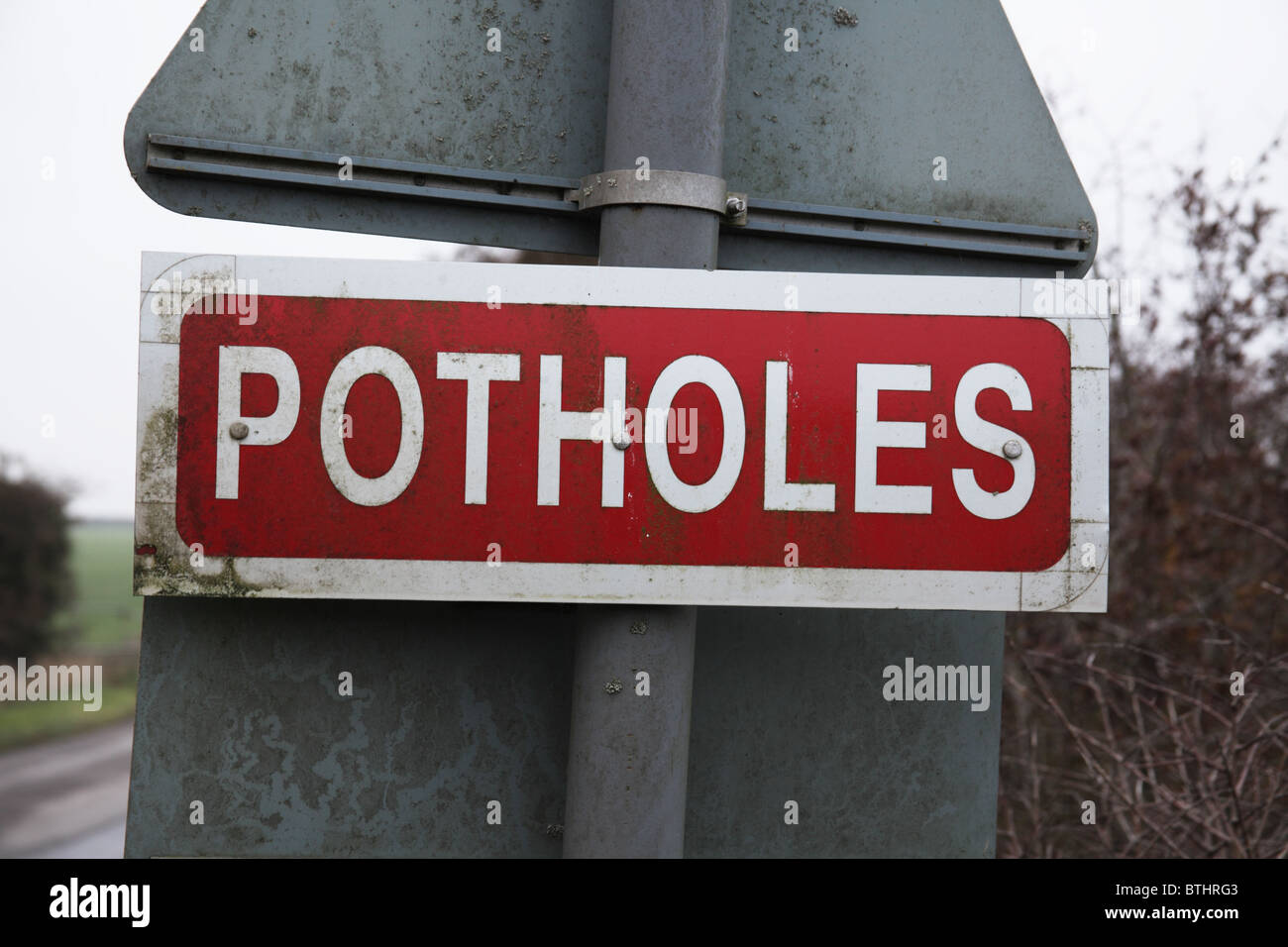 Potholes in Road sign Stock Photo - Alamy