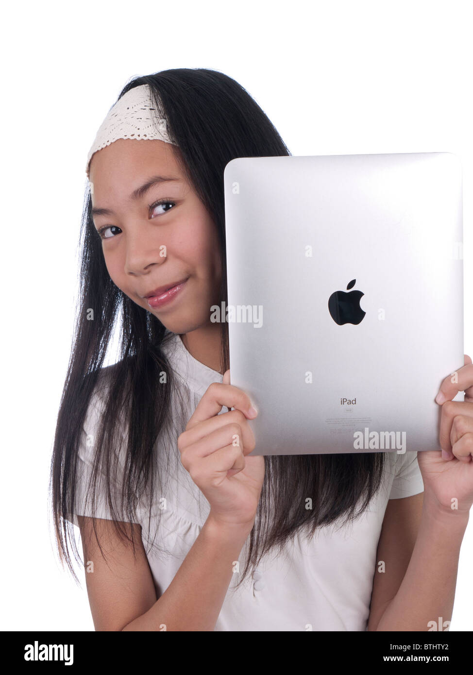 A teenage girl smiles while holding her iPad Stock Photo - Alamy