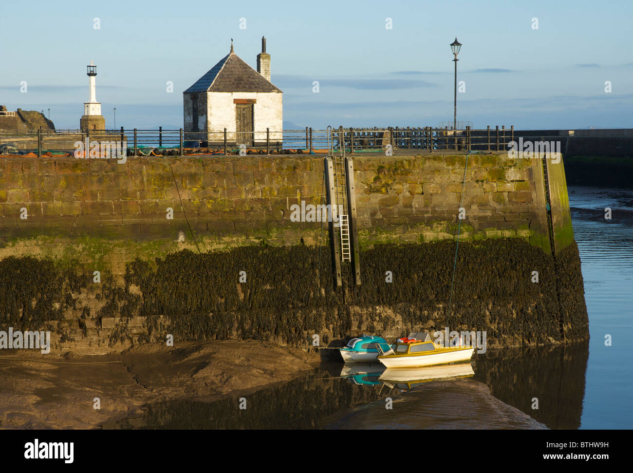 Harbour wall and lighthouse, Maryport, West Cumbria, England UK Stock ...