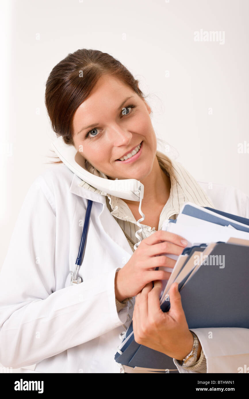 Female doctor on the phone with medical file and stethoscope Stock ...