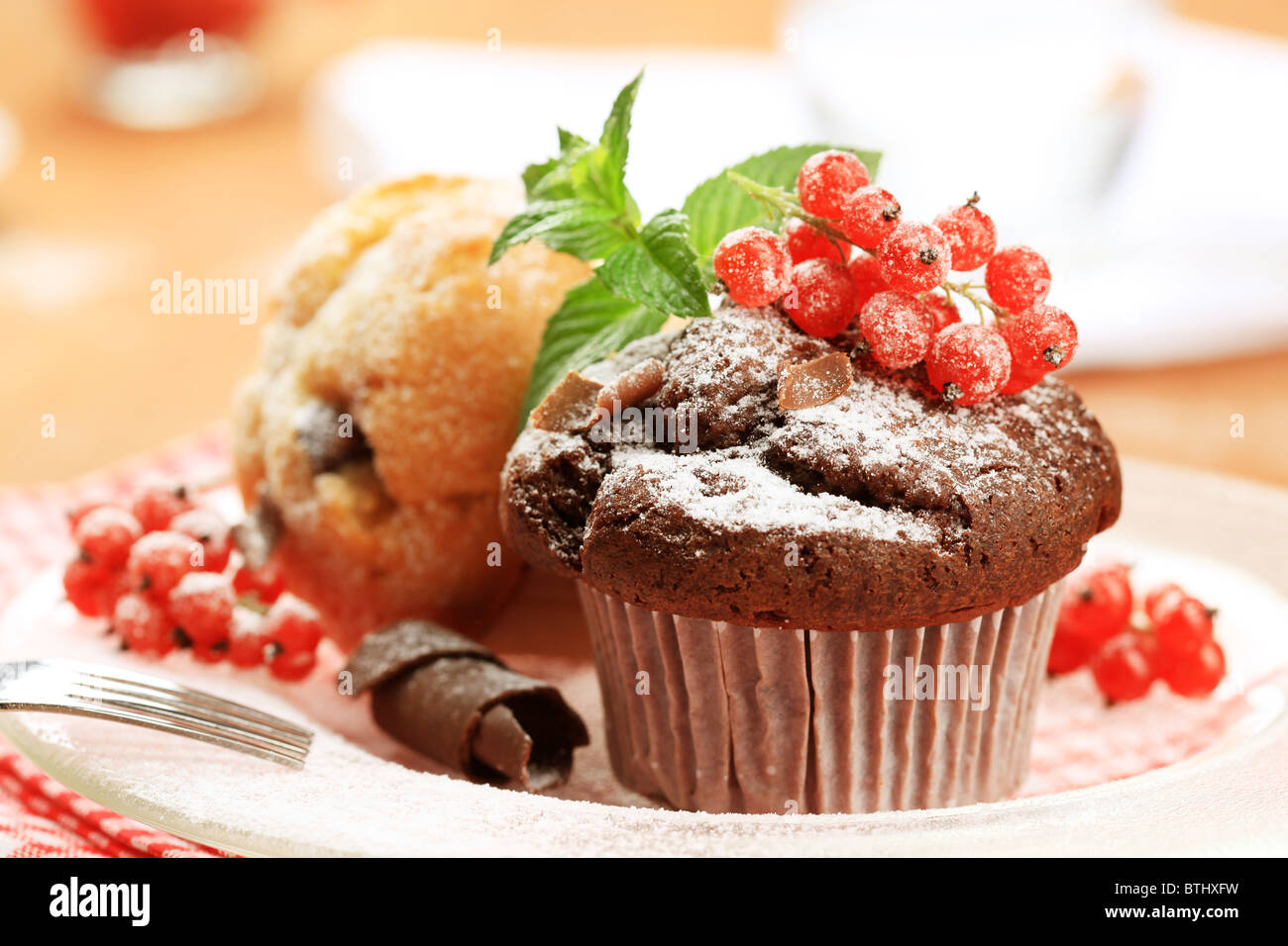 Two fresh muffins styled with red currant Stock Photo - Alamy