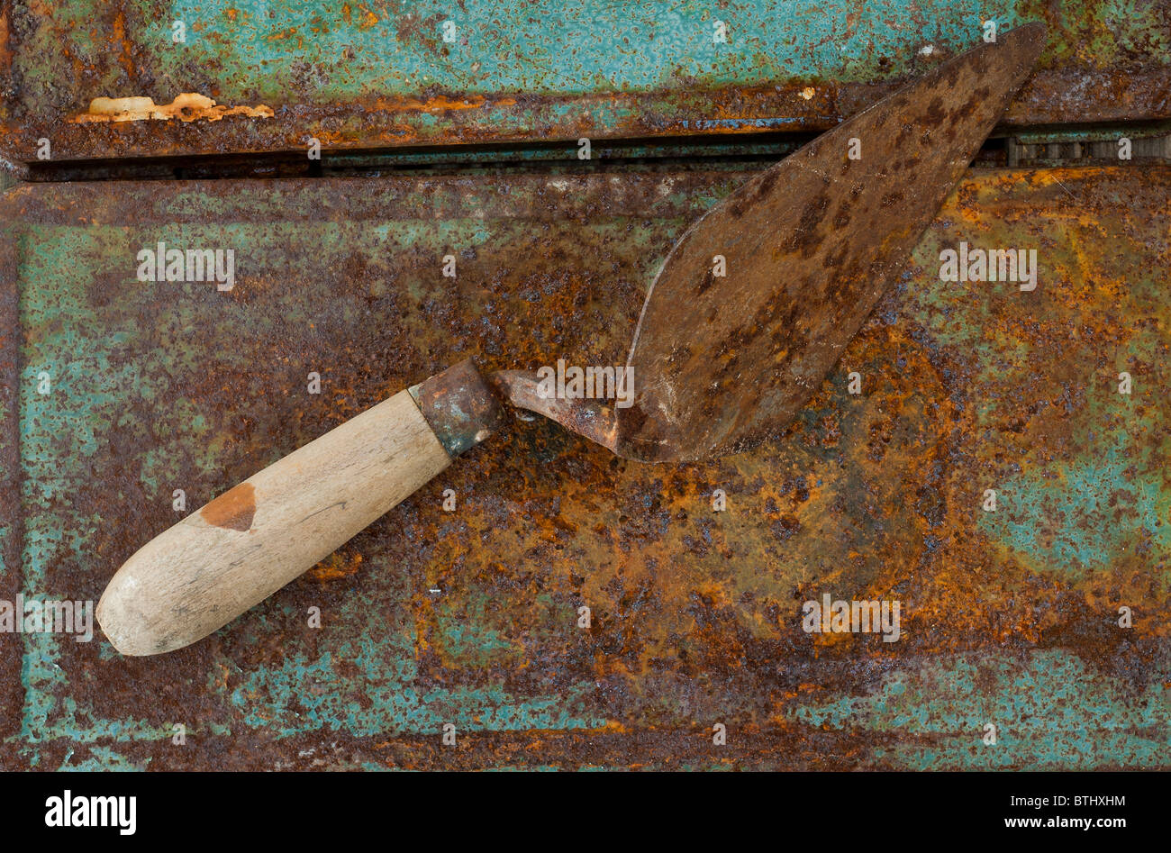 Bricklayers Trowel on a rusty background Stock Photo - Alamy