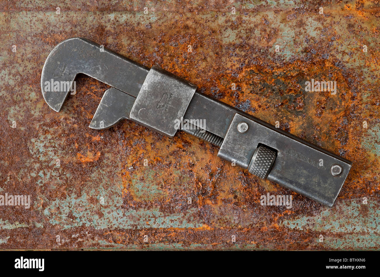 Adjustable Spanner on a rusty background Stock Photo - Alamy