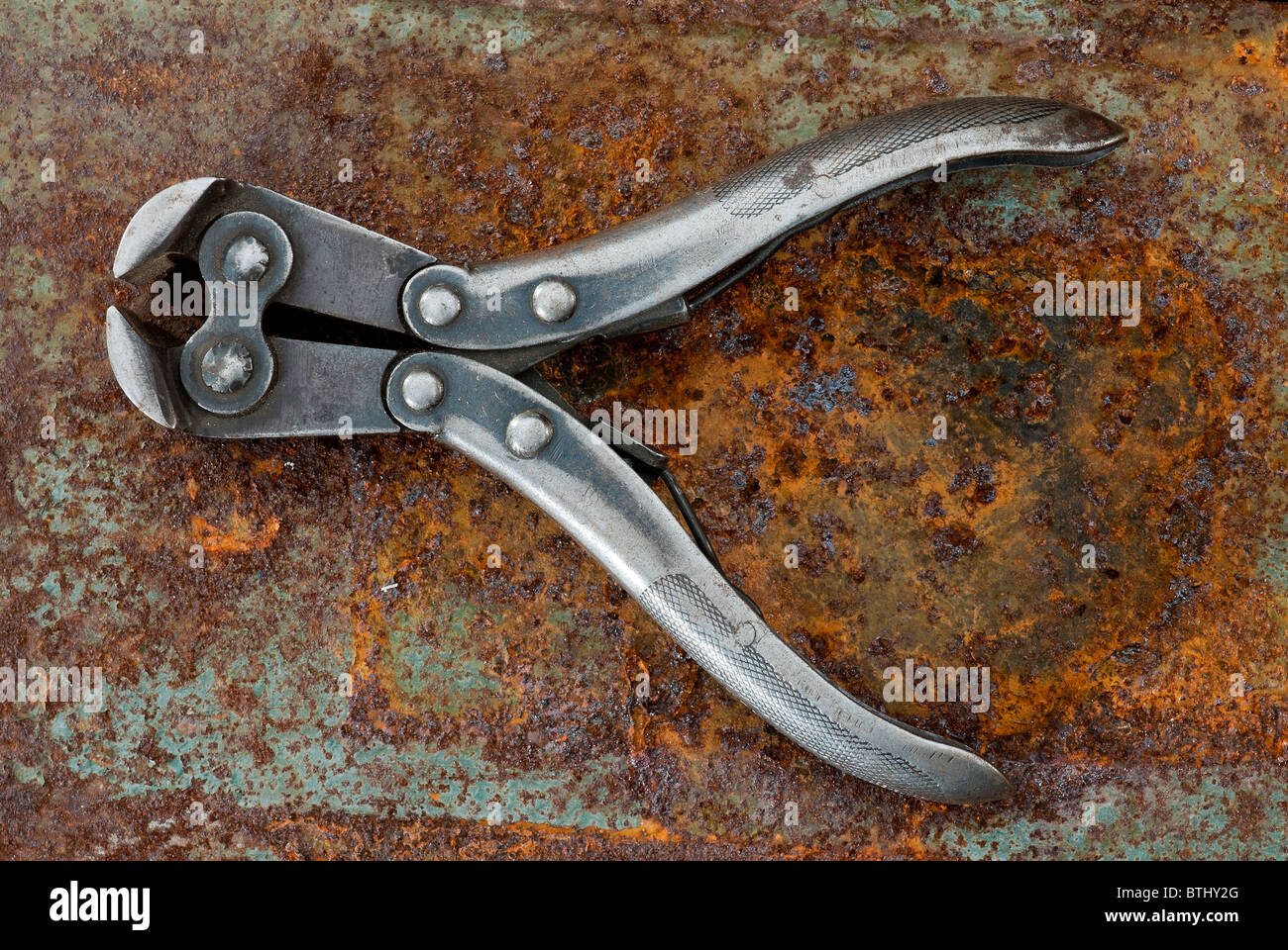 Pair of Pincer Pliers on a rusty background Stock Photo - Alamy