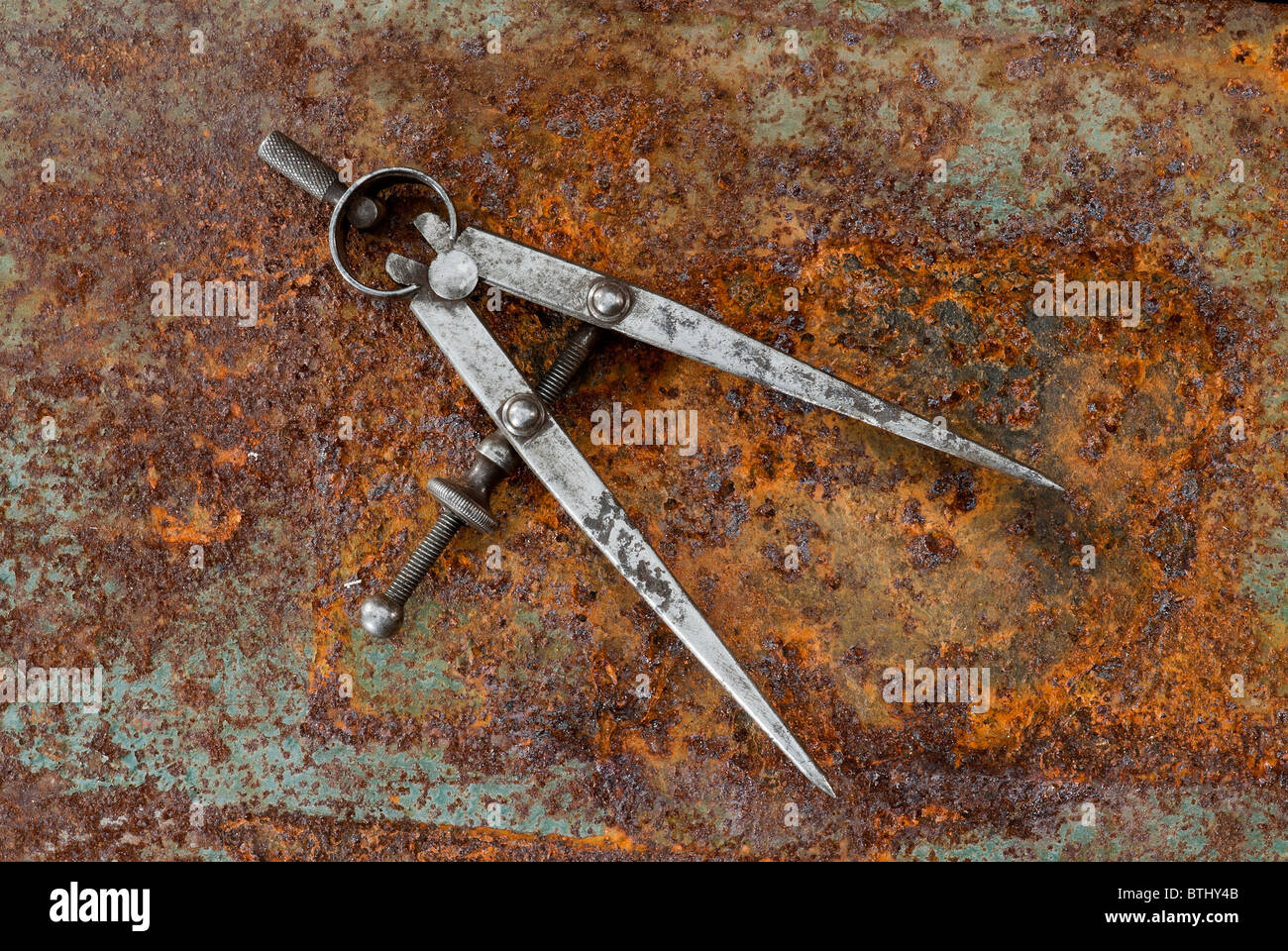 Pair of Dividers on a rusty background Stock Photo - Alamy