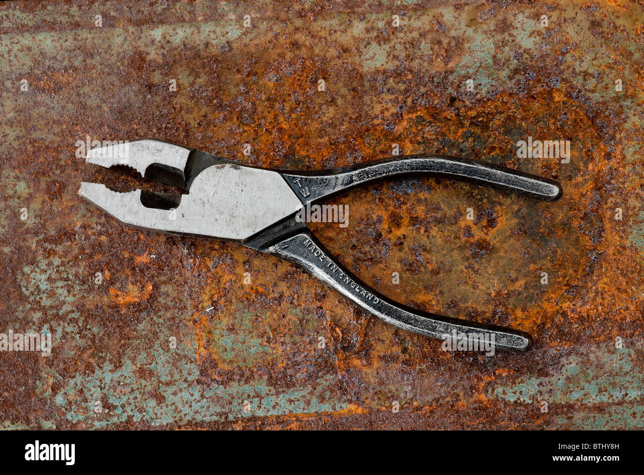 Pair of Linesman's Pliers on a rusty background Stock Photo - Alamy