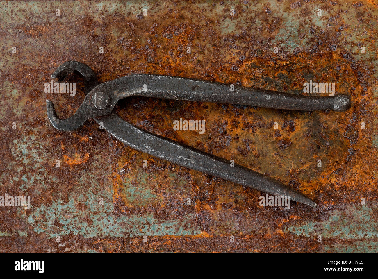 Pair of Pincer Pliers on a rusty background Stock Photo - Alamy