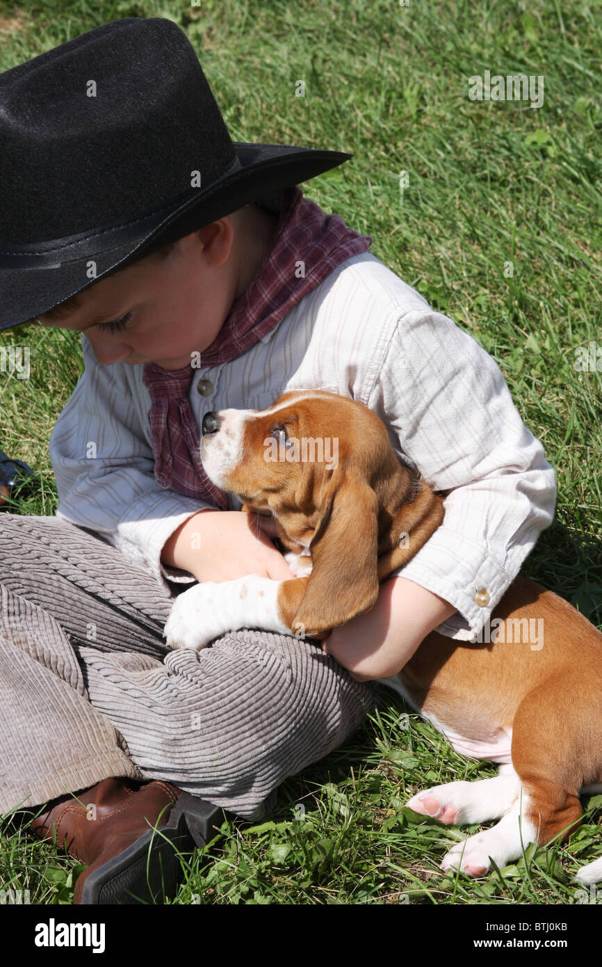 A young cowboy holding a small Beagle puppy Stock Photo - Alamy