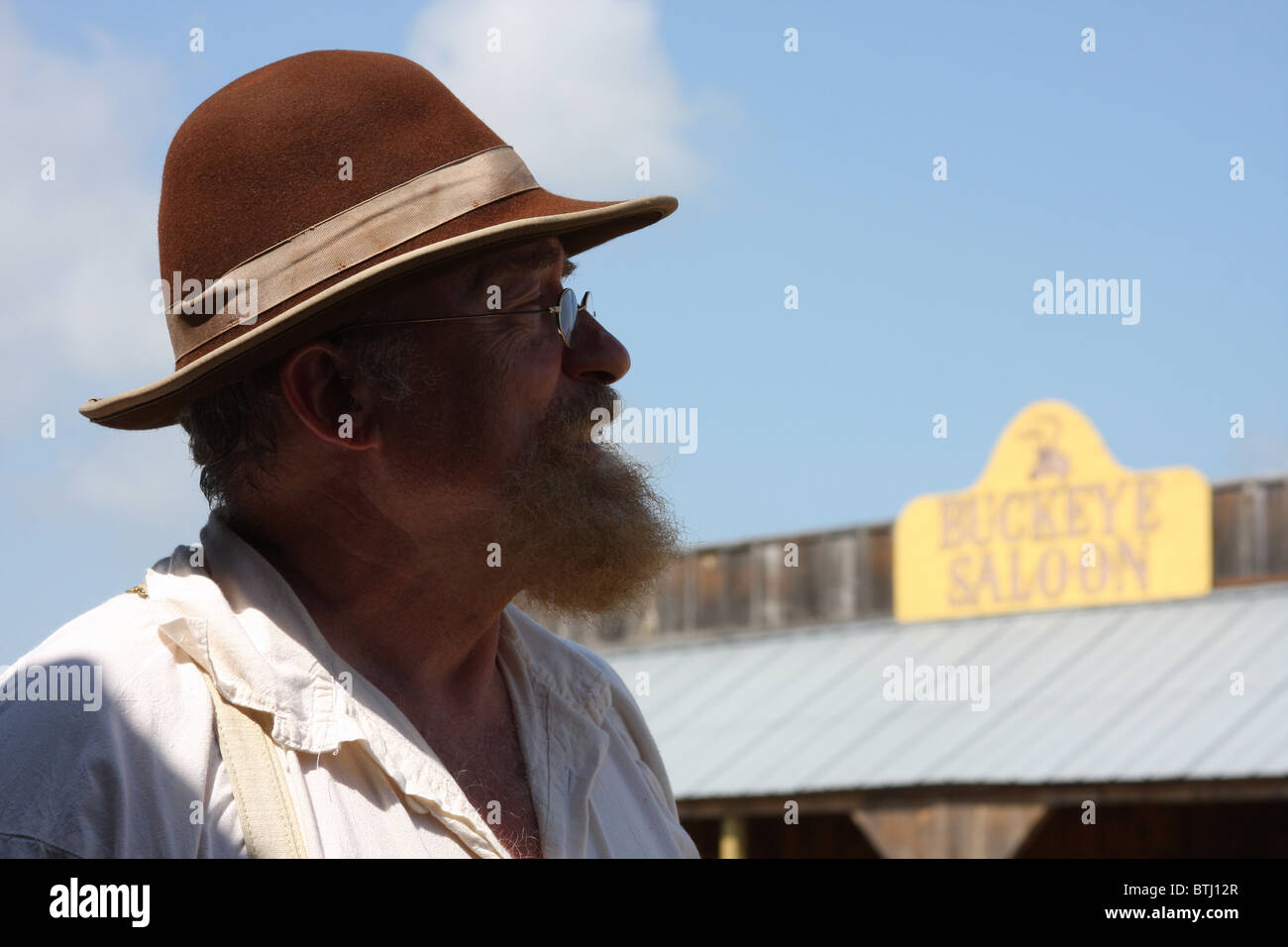 A western cowboy standing in front of a Buckeye Saloon Stock Photo - Alamy