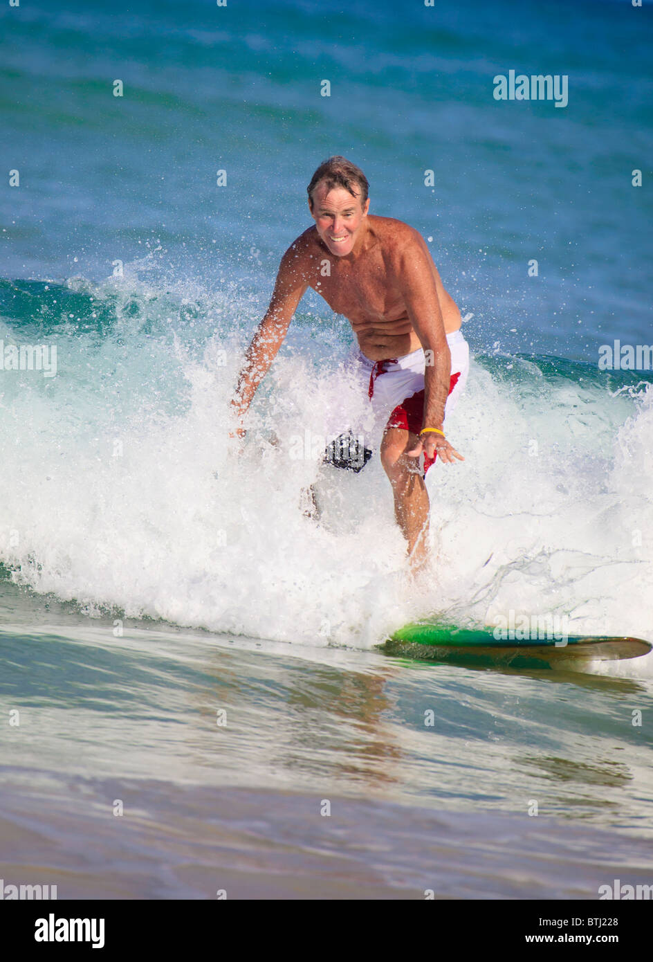 sixty four year old man surfing Stock Photo - Alamy
