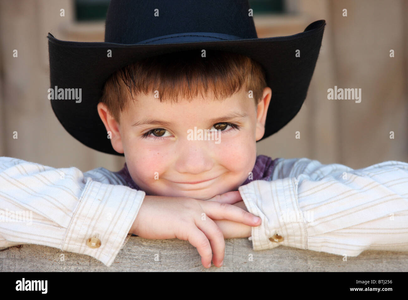 A portrait of a smiling young cowboy in an old west town Stock Photo ...