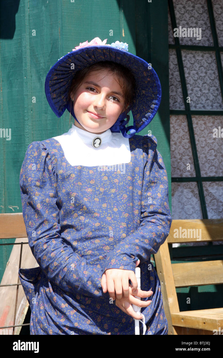 A young proper western girl dressed up in a old west town lady Stock ...