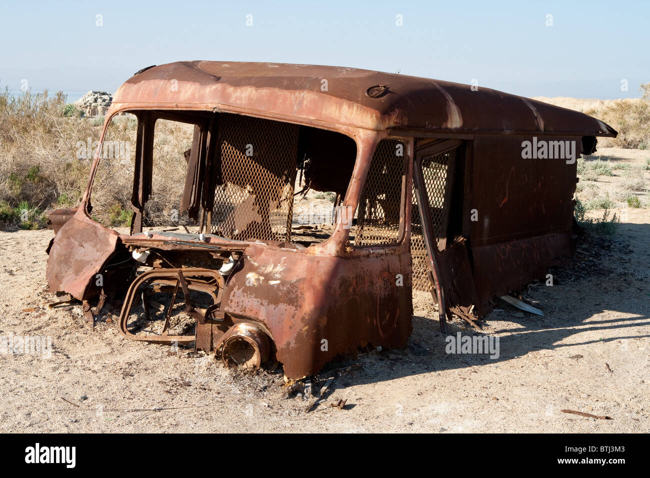 A rusty delivery van half sunk into the mud near Bombay Beach, Salton ...