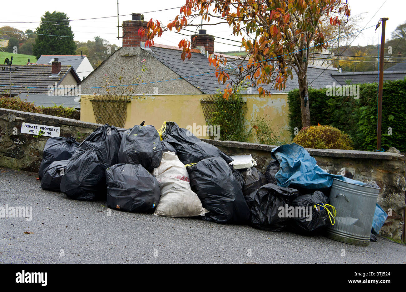 household waste on the roadside waiting to be collected by the local ...