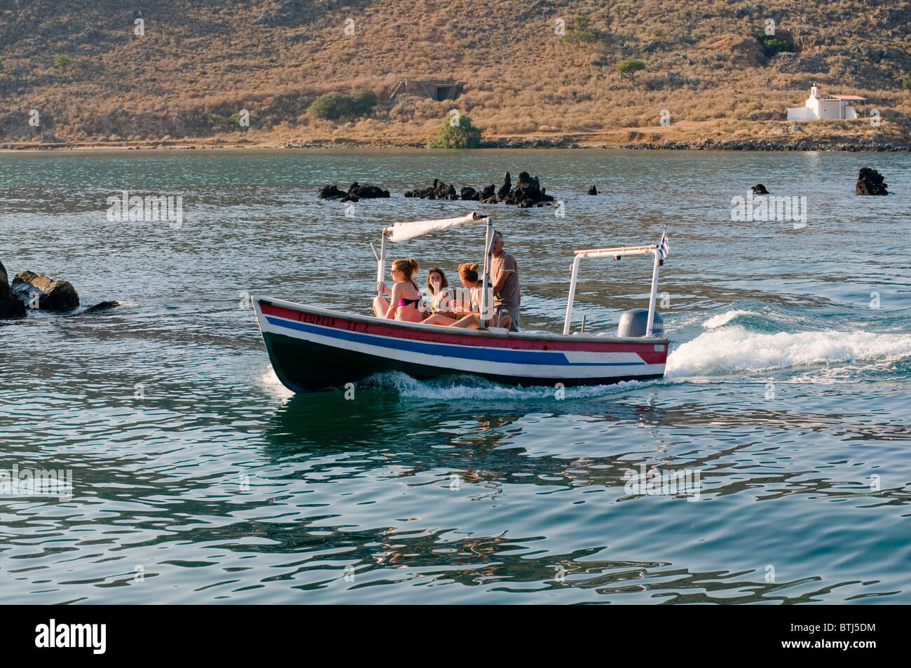 Boat entering the harbour at Georgioupolis Crete Stock Photo - Alamy