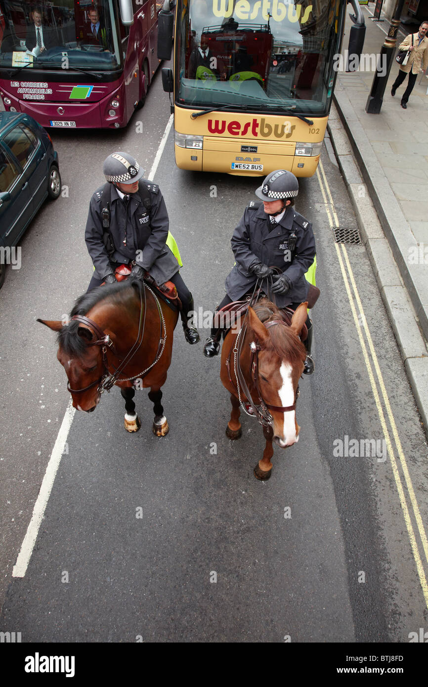 Mounted police in traffic, Whitehall, London, England, United Kingdom ...