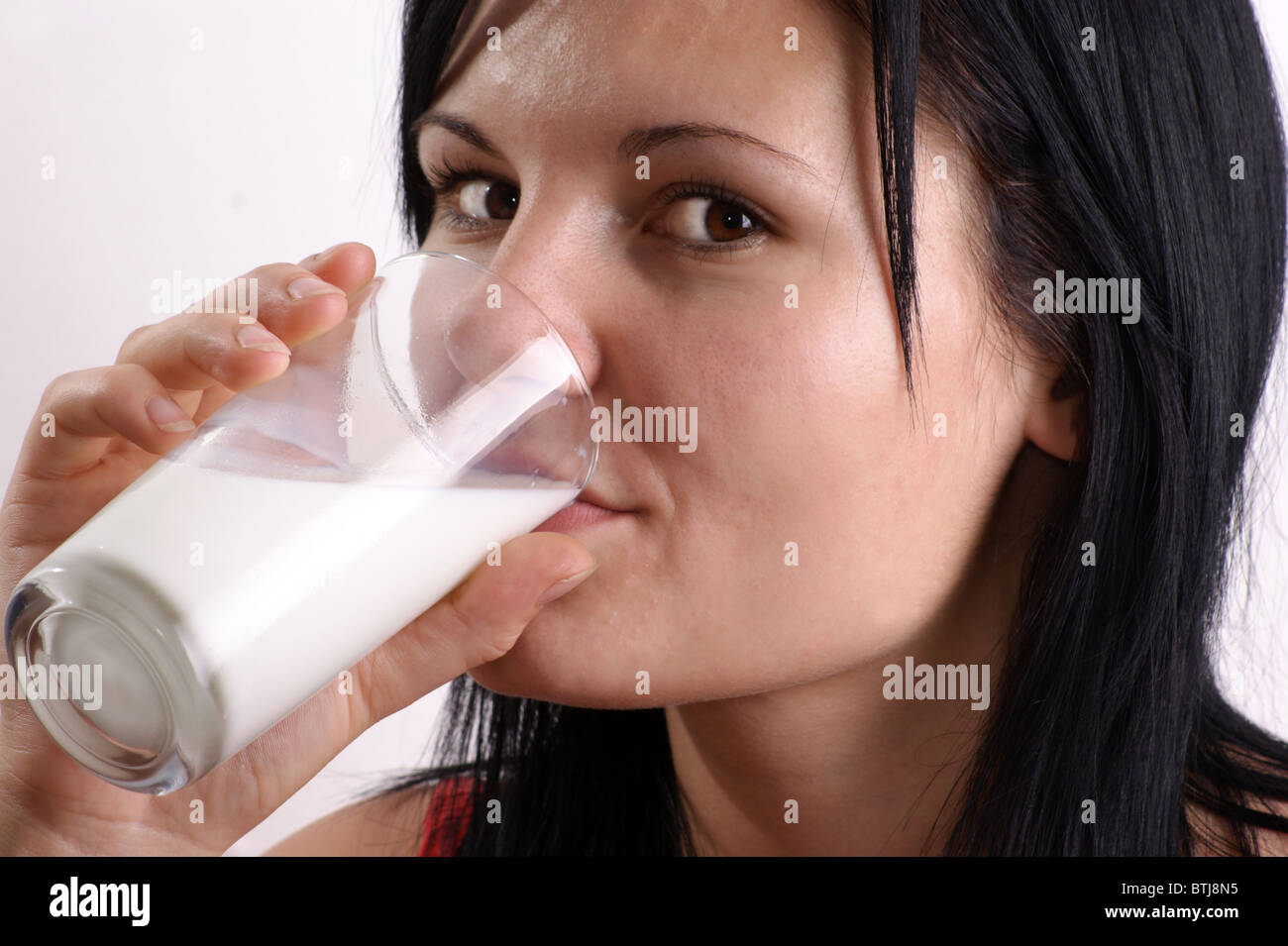a young woman drinks organic cold milk Stock Photo - Alamy