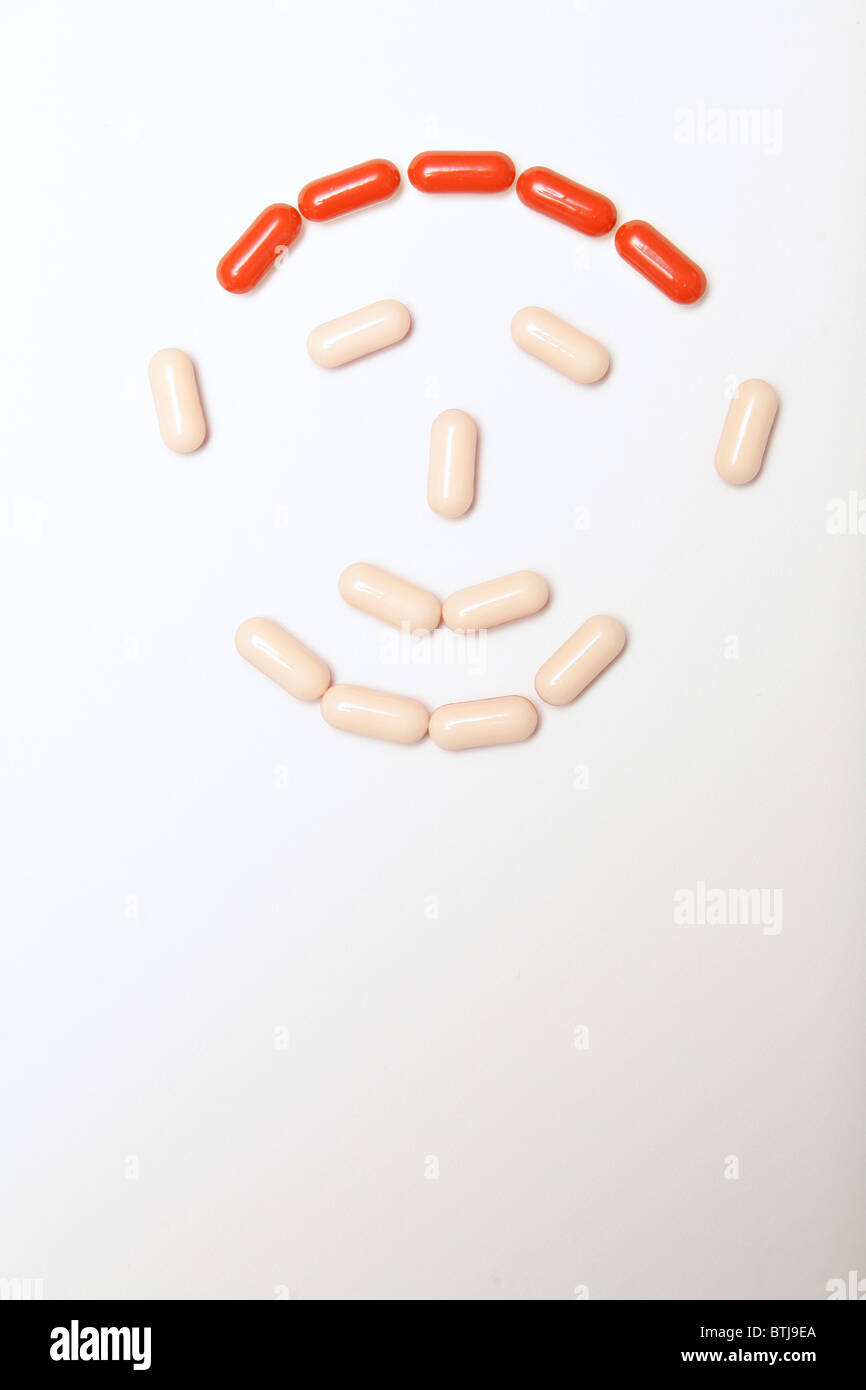 medication and pills face on gray background Stock Photo - Alamy