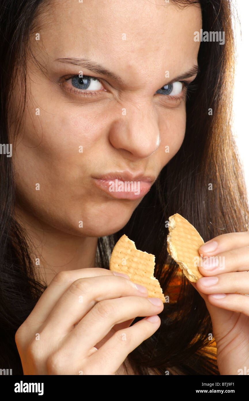 a young woman likes her home made biscuit Stock Photo - Alamy