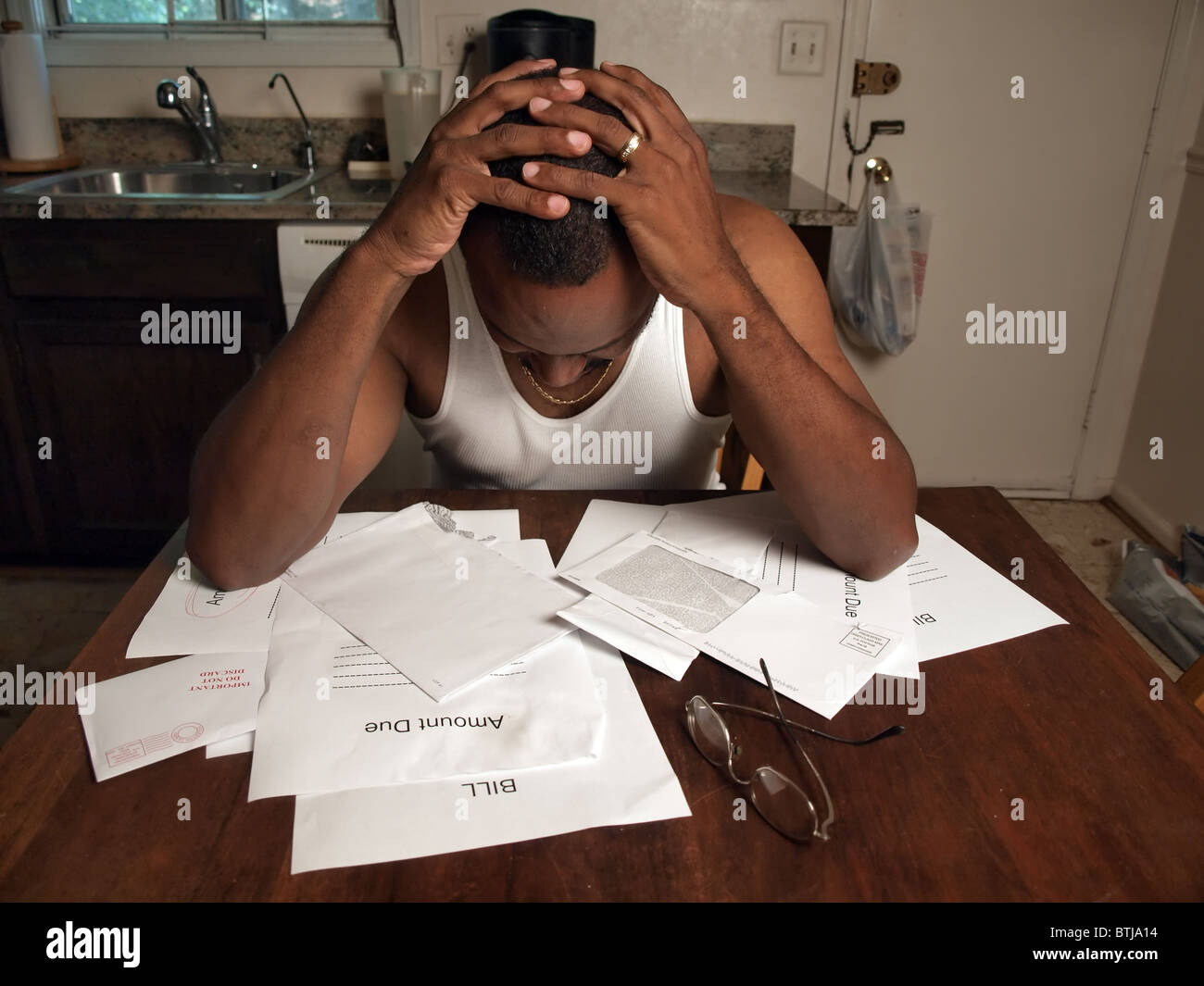 african american man holding his head as if under stress of his ...